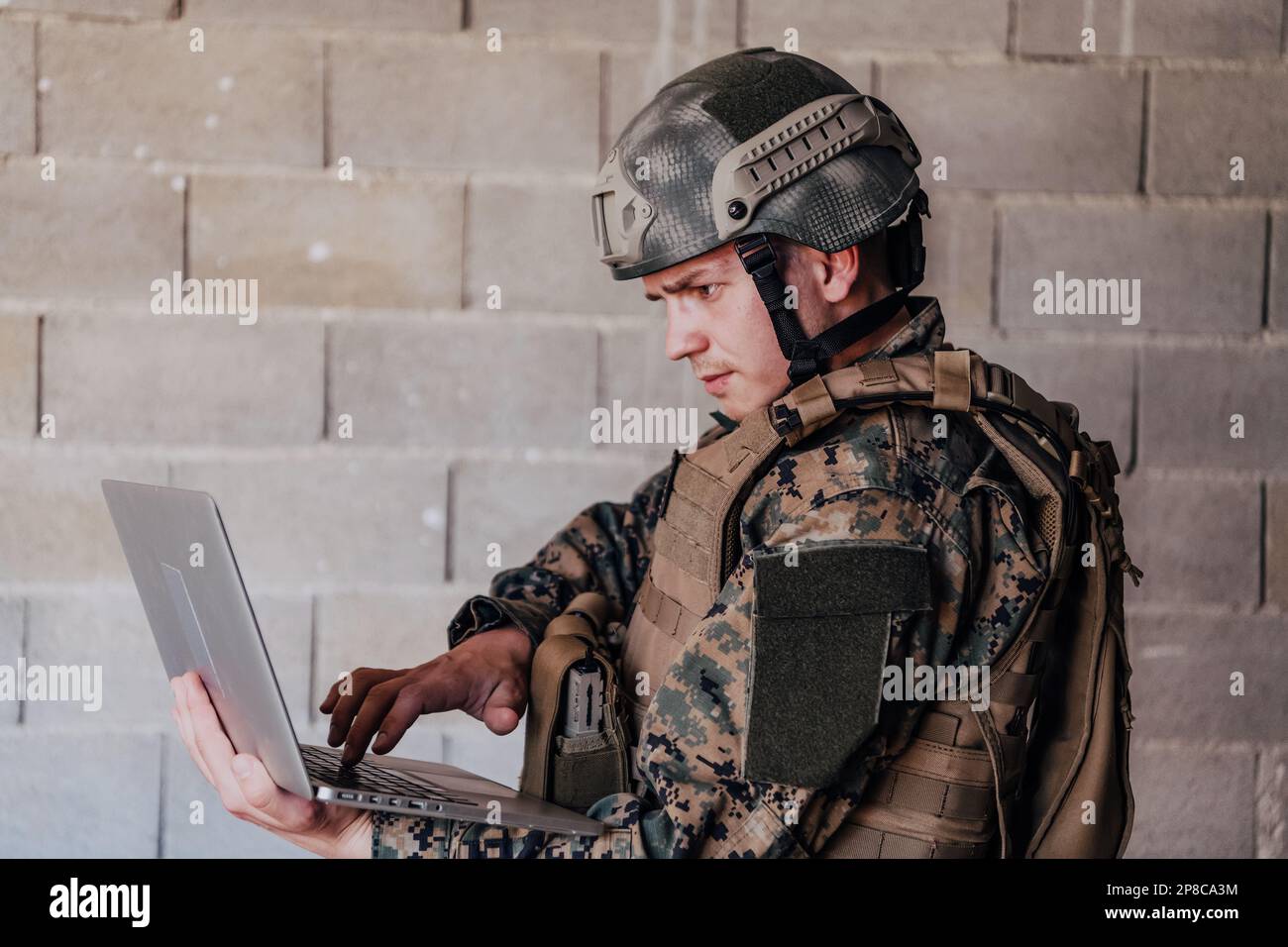 American soldier in military uniform using laptop computer for drone ...
