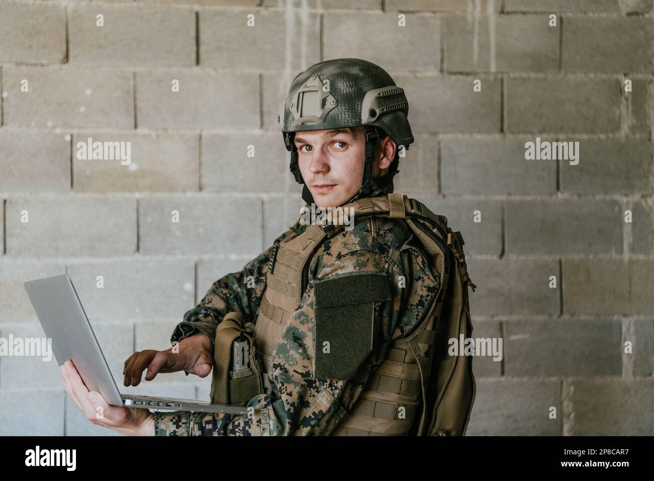 American soldier in military uniform using laptop computer for drone ...