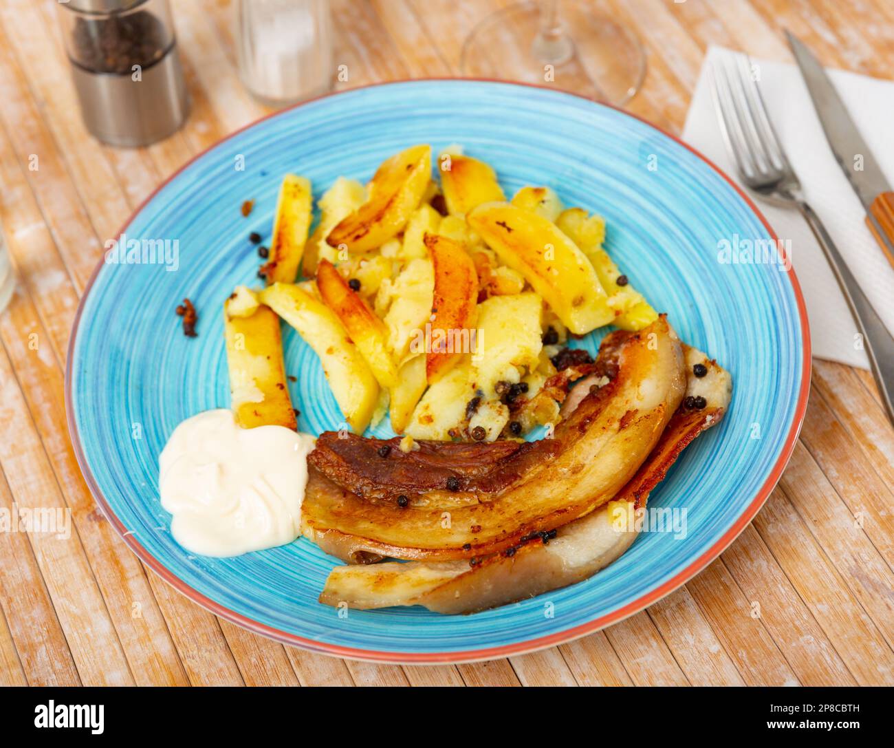 Roasted pork side bacon served with fried potato Stock Photo - Alamy