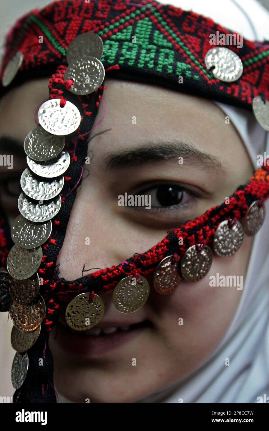 A Palestinian model displays a traditional Palestinian customs in a ...