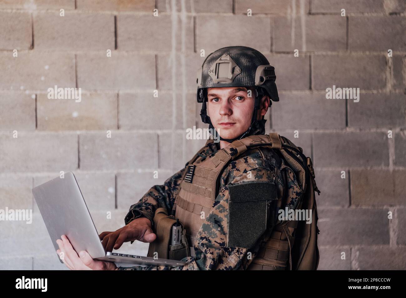 American soldier in military uniform using laptop computer for drone ...