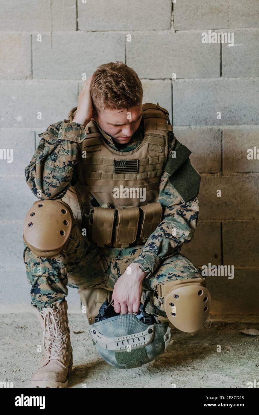 Upset soldier has psychological problems holding his head Stock Photo ...