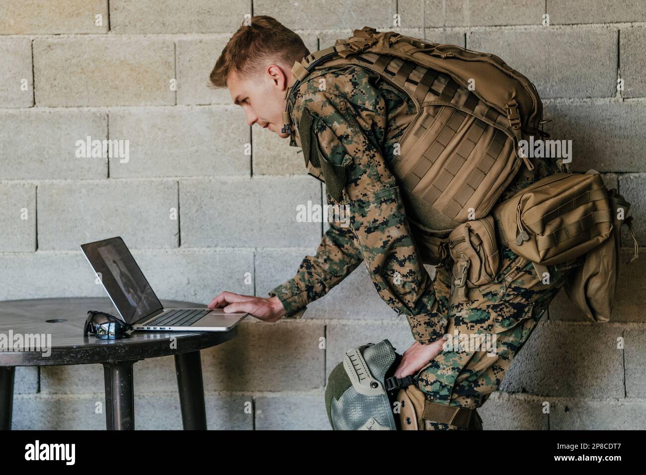 American soldier in military uniform using laptop computer for drone ...