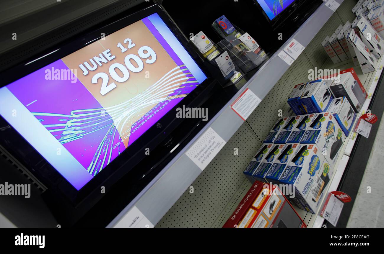 A TV displays an ad for the conversion to digital TV as converter box's ...