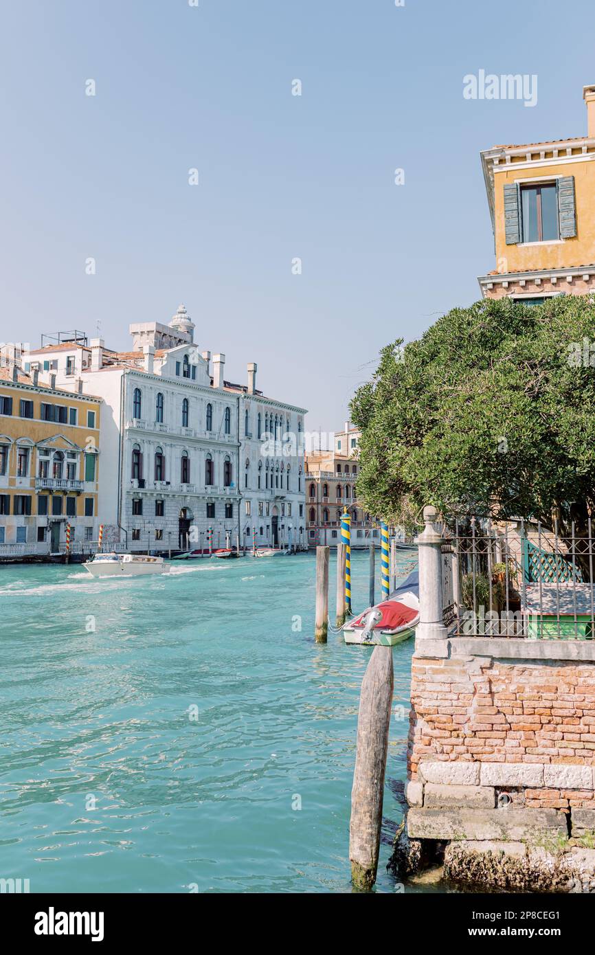 A motorboat cruises a river in Venice, with the city in the background ...