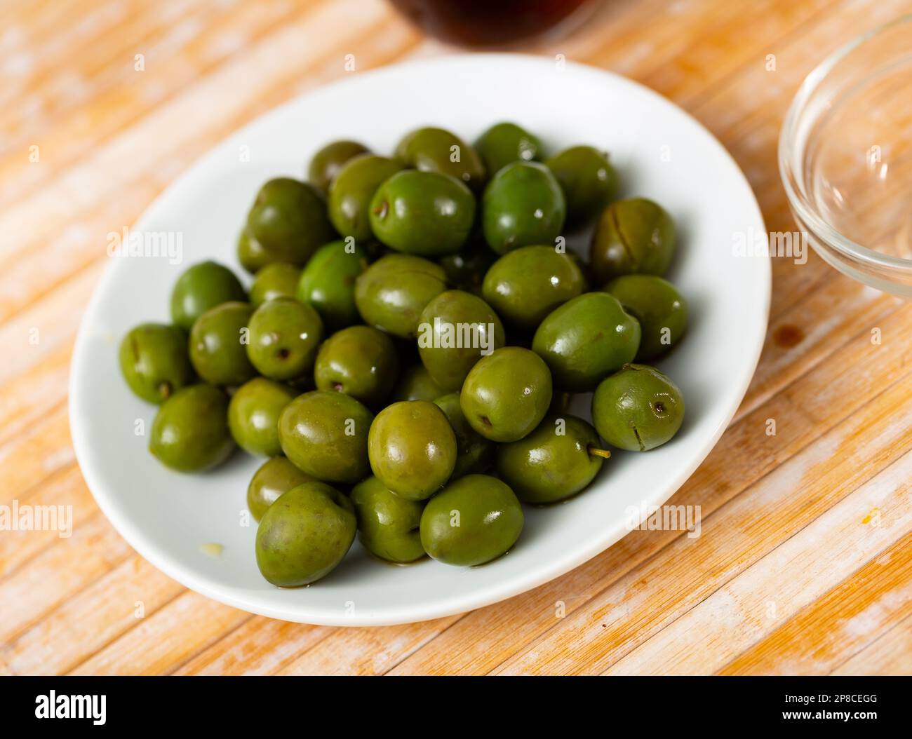 Pickled green olives with a stone Stock Photo - Alamy
