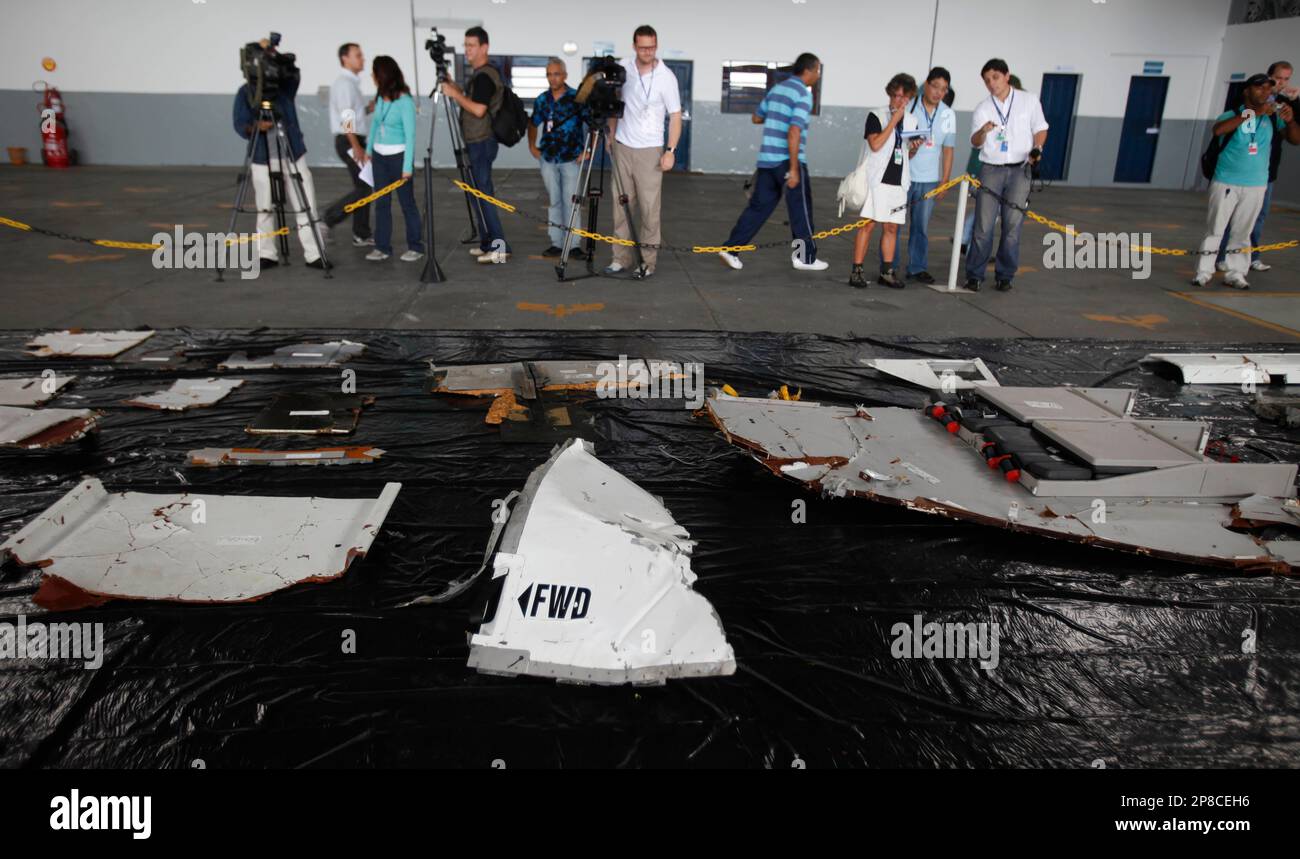 Journalists look at debris of the missing Air France flight 447 after ...