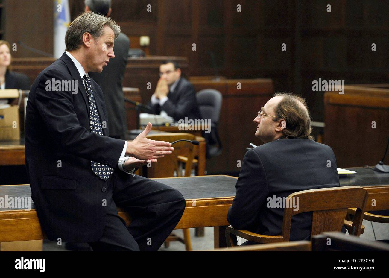 Defense attorney Timothy Bradl, left, talks to Christian Karl ...