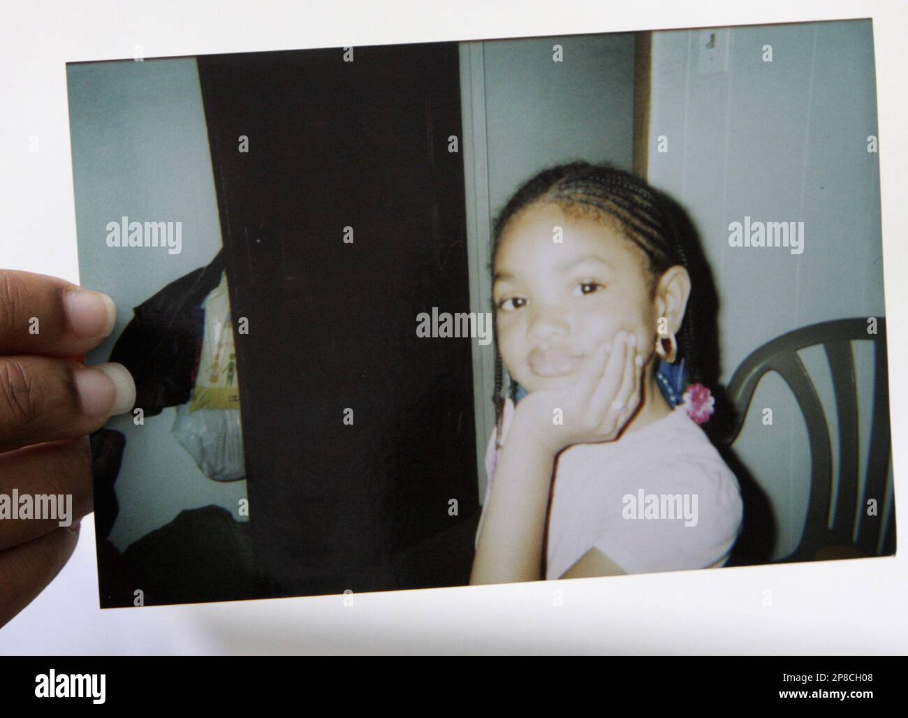A mourner holds an undated photo accident victim Alliyah Griffin during ...