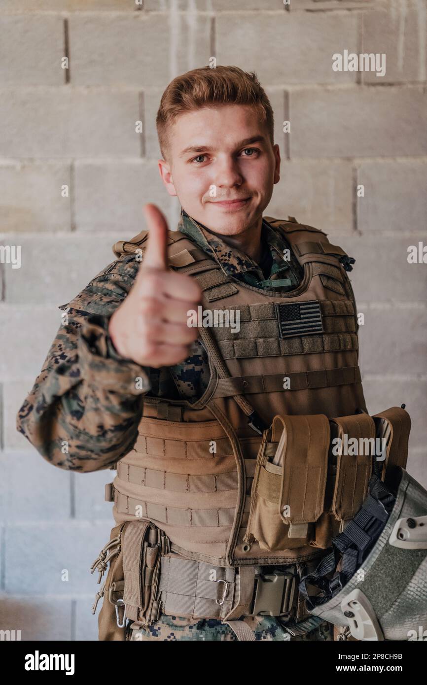 The soldier makes a gesture of success with his hand. A soldier in full ...