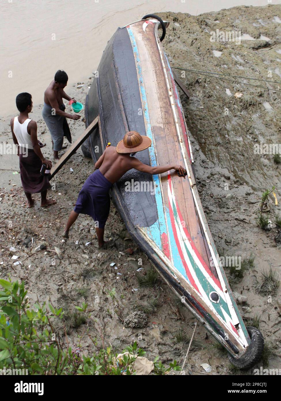 Myanmars repair a boat at the outskirts of Yangon, Myanmar on Thursday ...