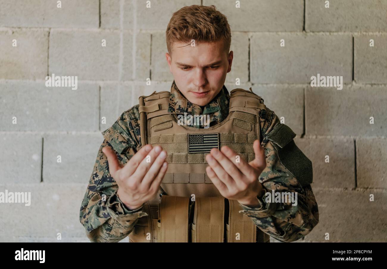 A Muslim soldier of the special forces prays to God by raising his ...
