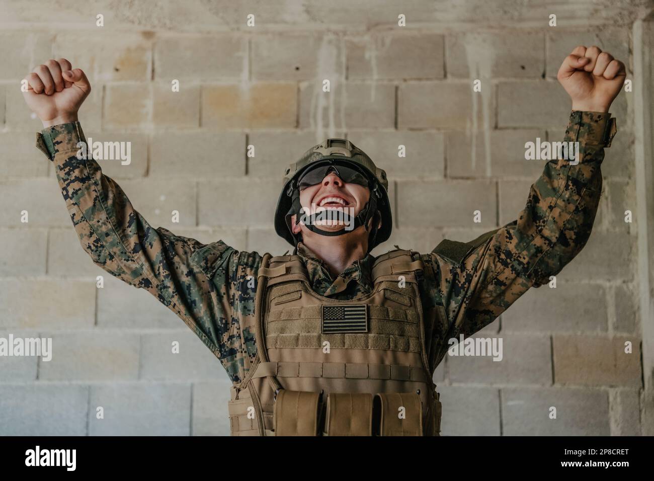Success in the war campaign. A soldier with raised hands celebrates the ...