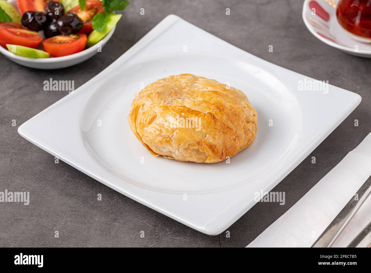 Izmir boyoz on a white porcelain plate on a stone table Stock Photo - Alamy