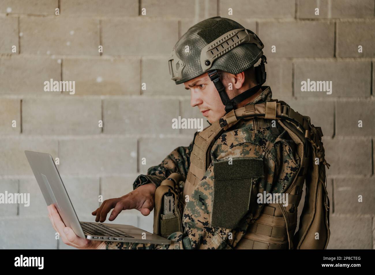 American soldier in military uniform using laptop computer for drone ...