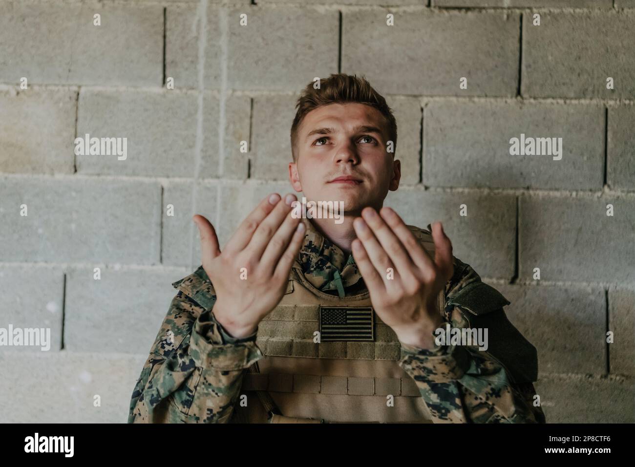 A Muslim soldier of the special forces prays to God by raising his ...