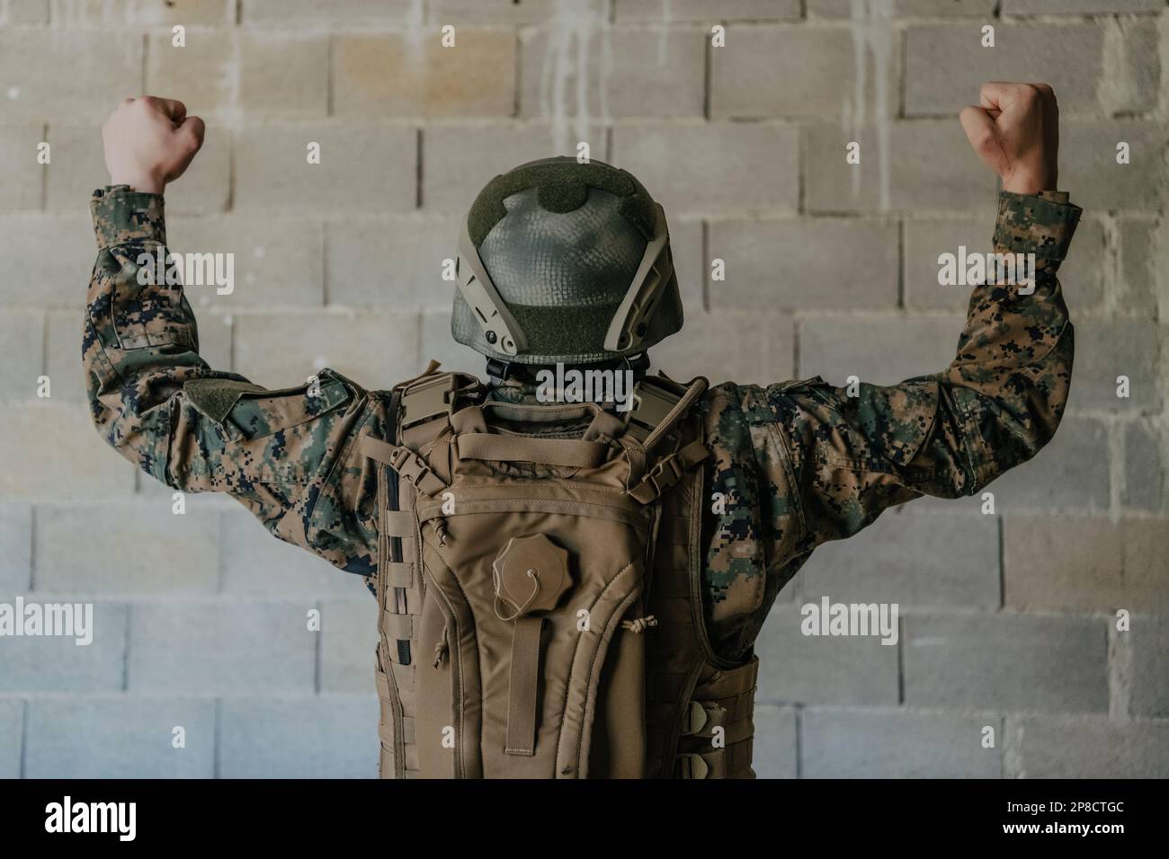 Success in the war campaign. A soldier with raised hands celebrates the ...