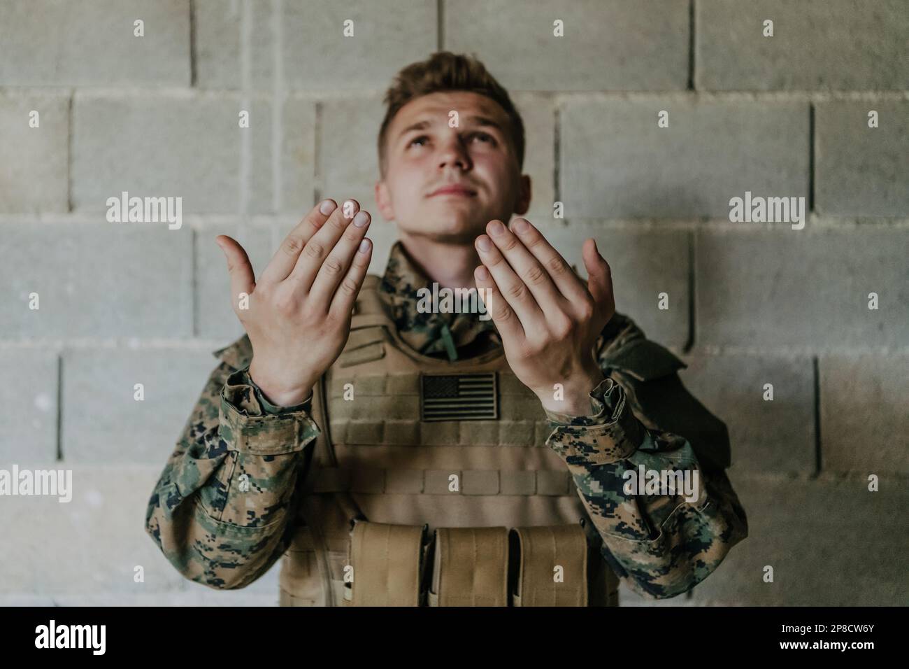 A Muslim soldier of the special forces prays to God by raising his ...