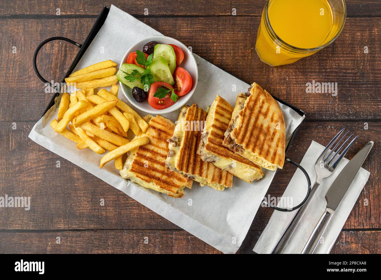 Turkish toast with roasted meat served with olives, cucumbers and ...