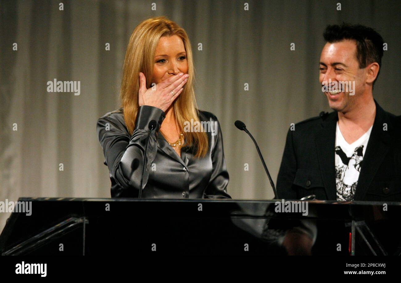 Actor Alan Cumming looks on as actress Lisa Kudrow delivers her ...