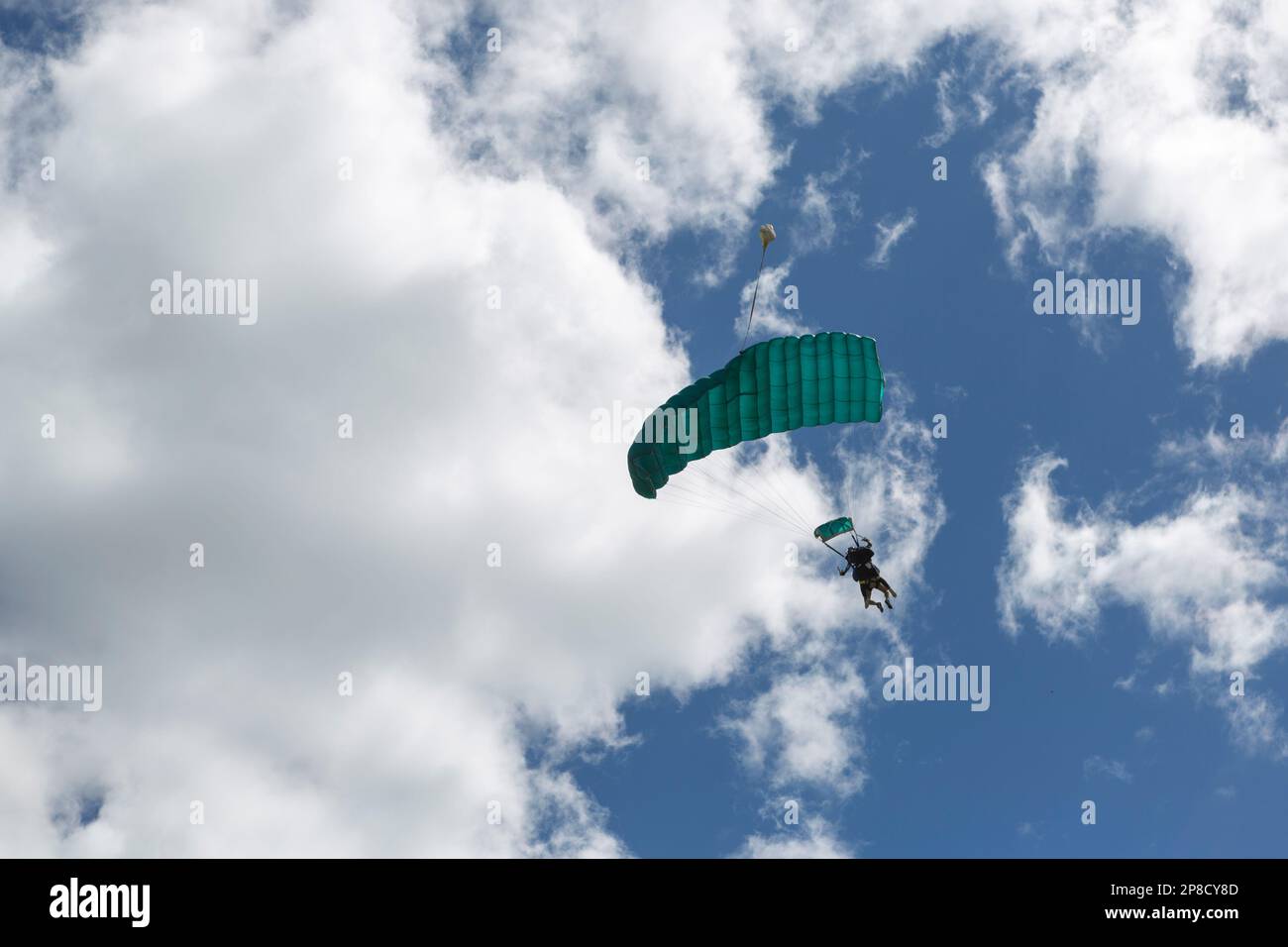 view of parachute descending with two people Stock Photo - Alamy