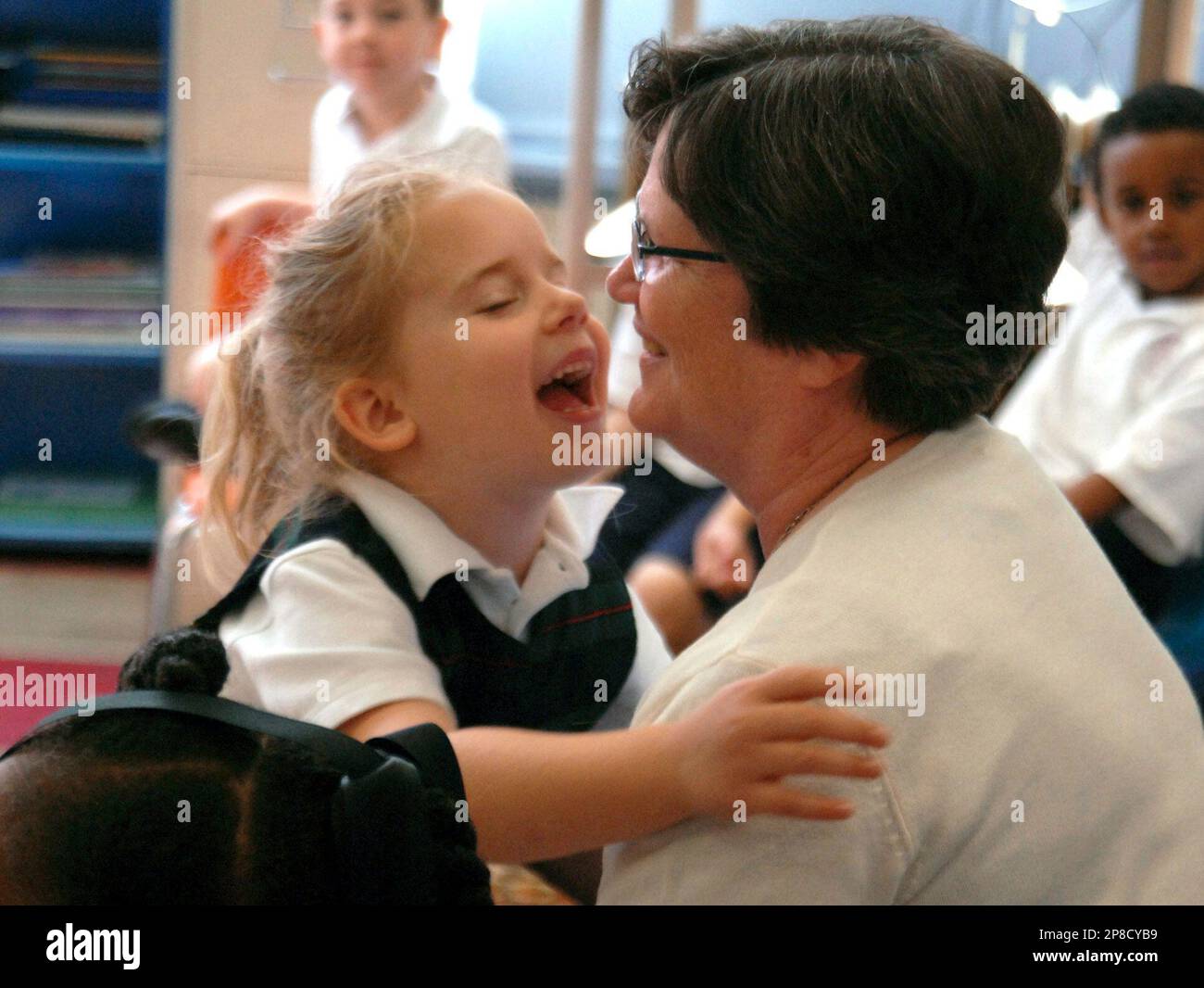 Sister Margaret Mary Scally gets a hug from Gracy Coover during music ...