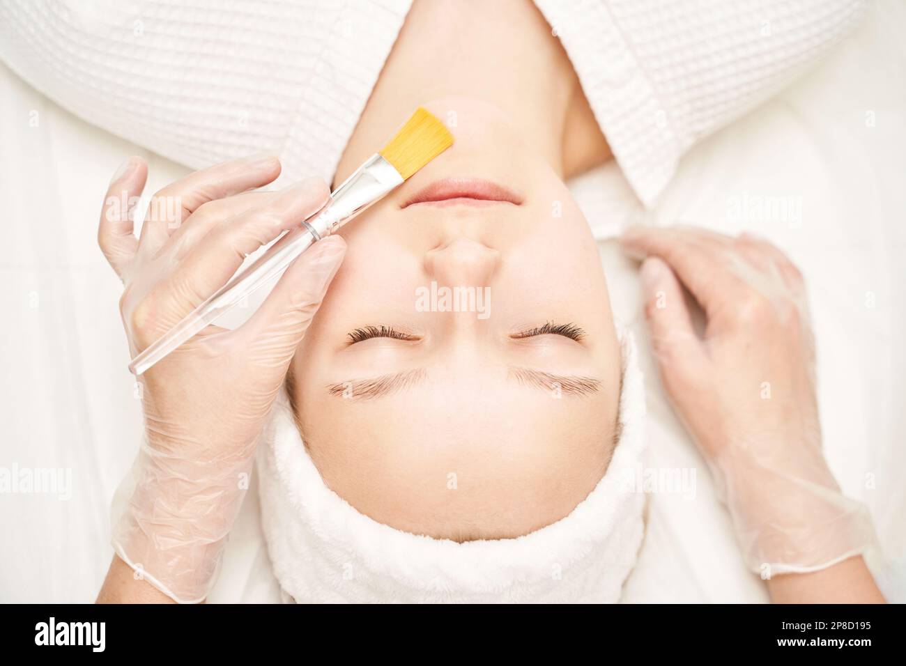 Cosmetology beauty procedure. Young woman skin care. Beautiful female ...