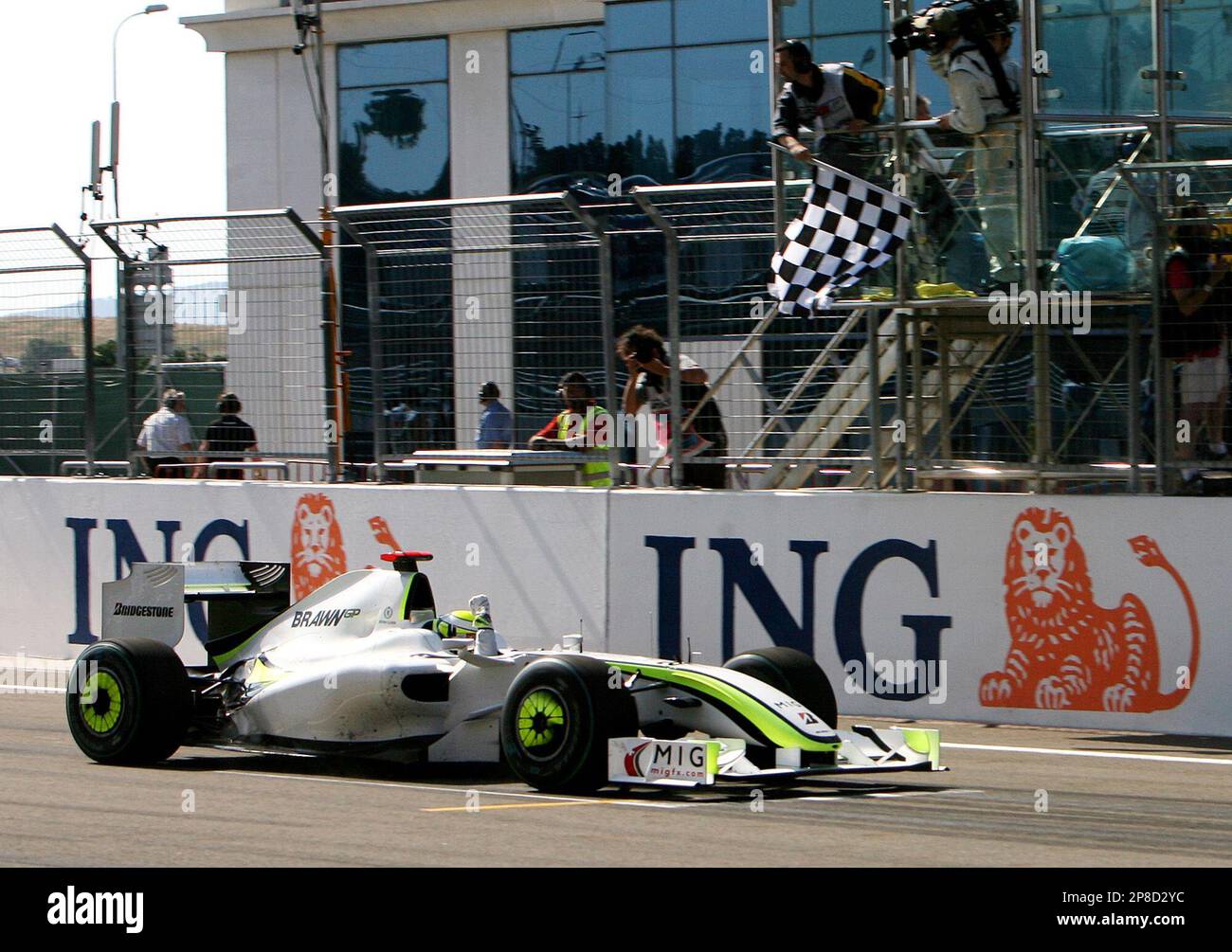 Brawn GP driver Jenson Button of Britain reacts as he crosses the ...