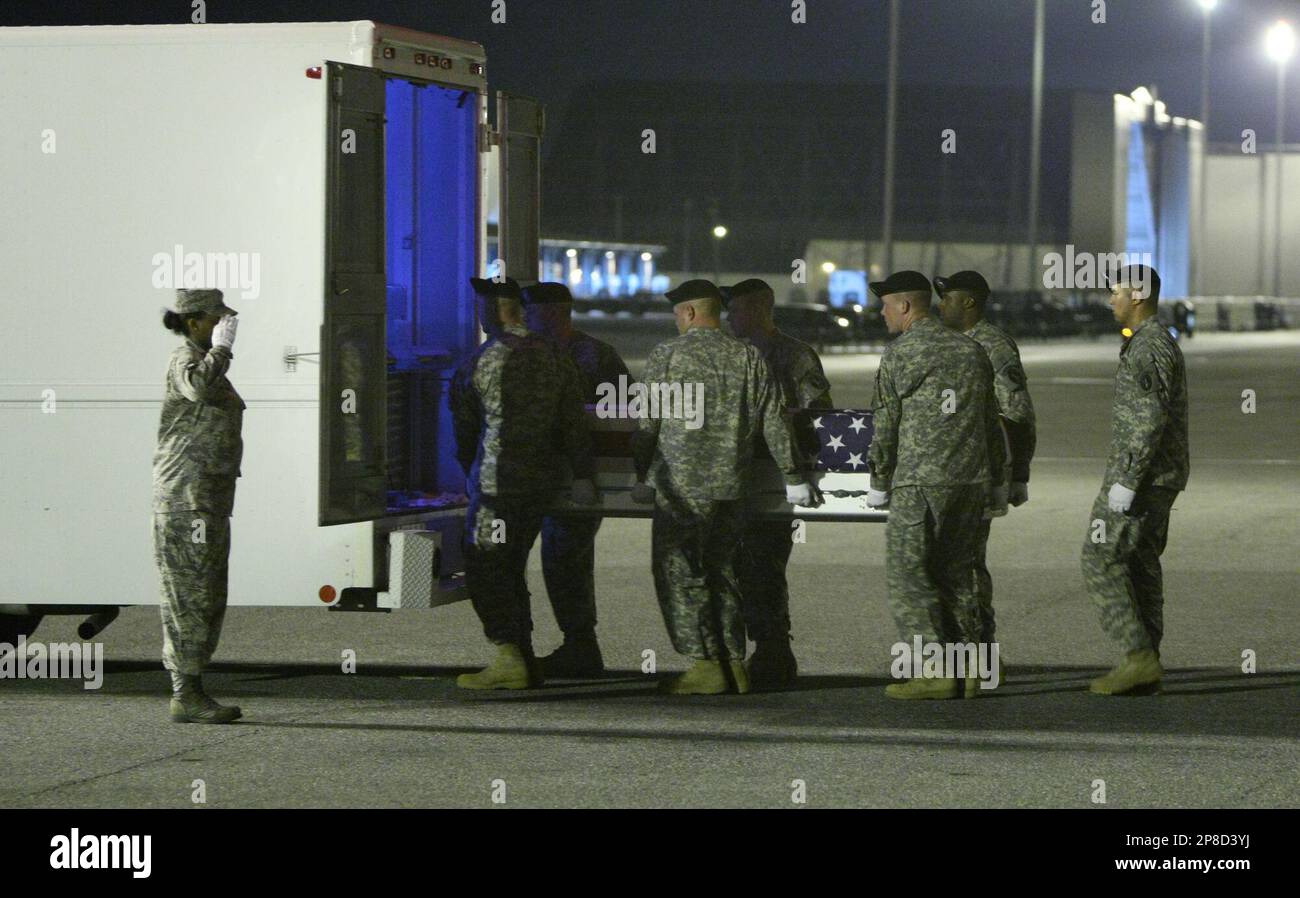 An Army carry team carries the transfer case containing the remains of ...
