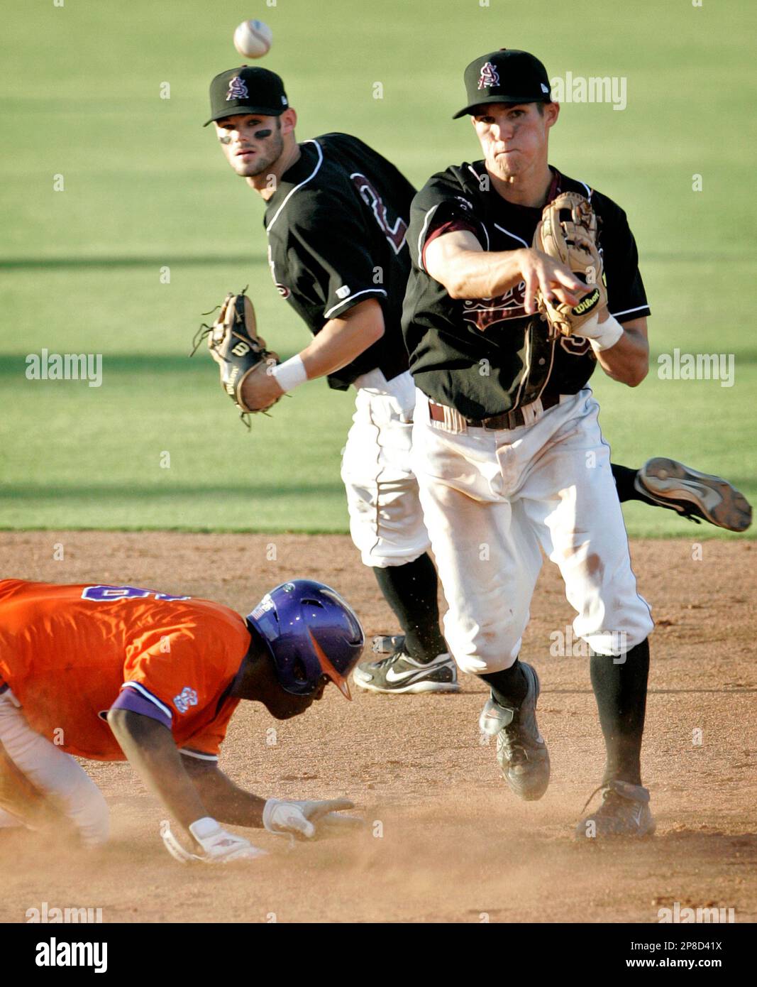 Arizona State's Zack MacPhee, rear, watches as Drew Maggi, right, turns ...