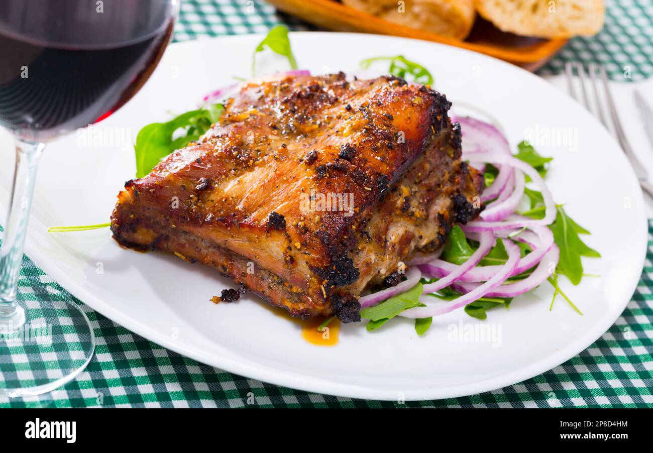 Roasted pork rack of ribs with greens Stock Photo - Alamy