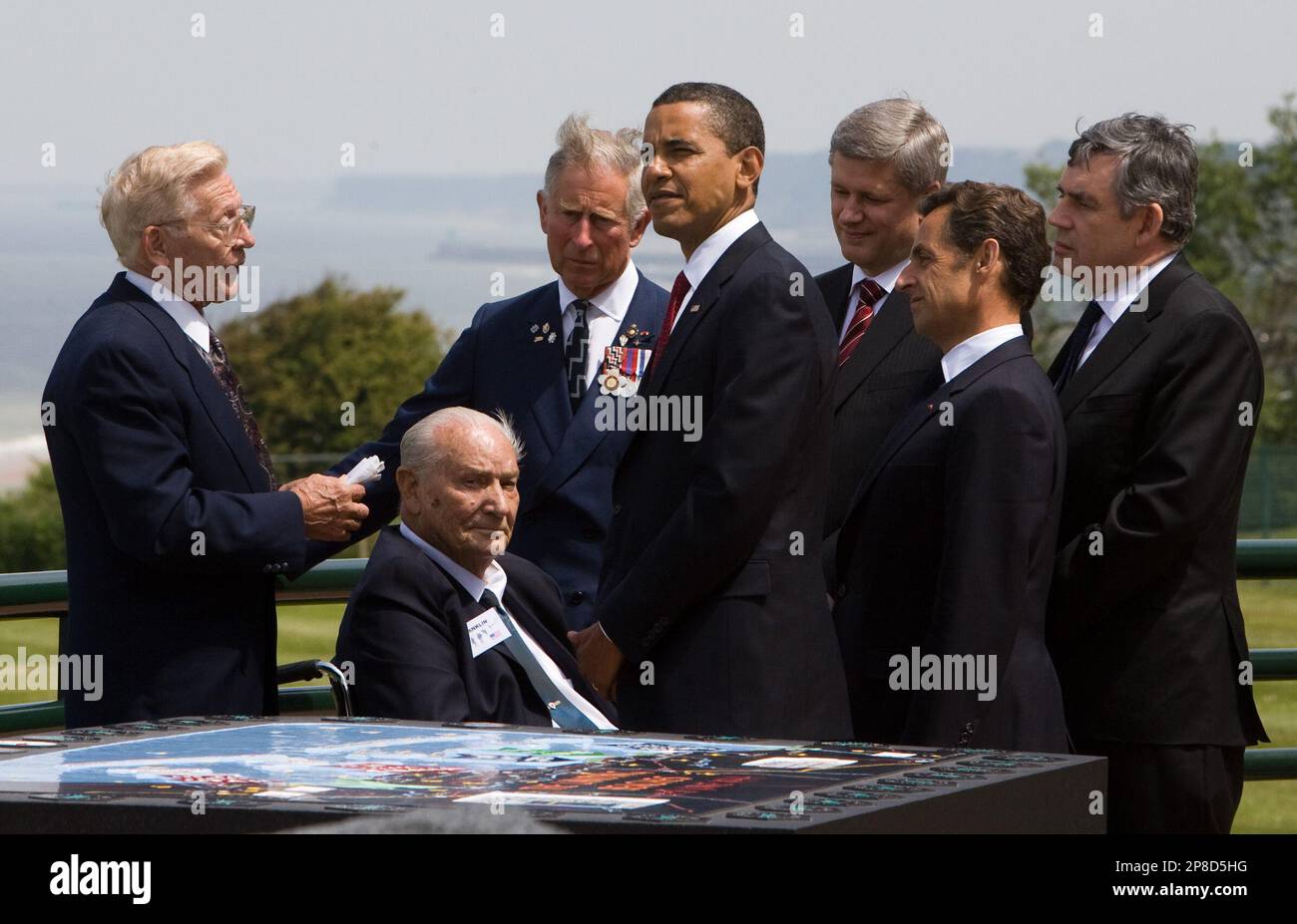 U.S. President Barack Obama, center, listens to D-Day veteran Clyde ...