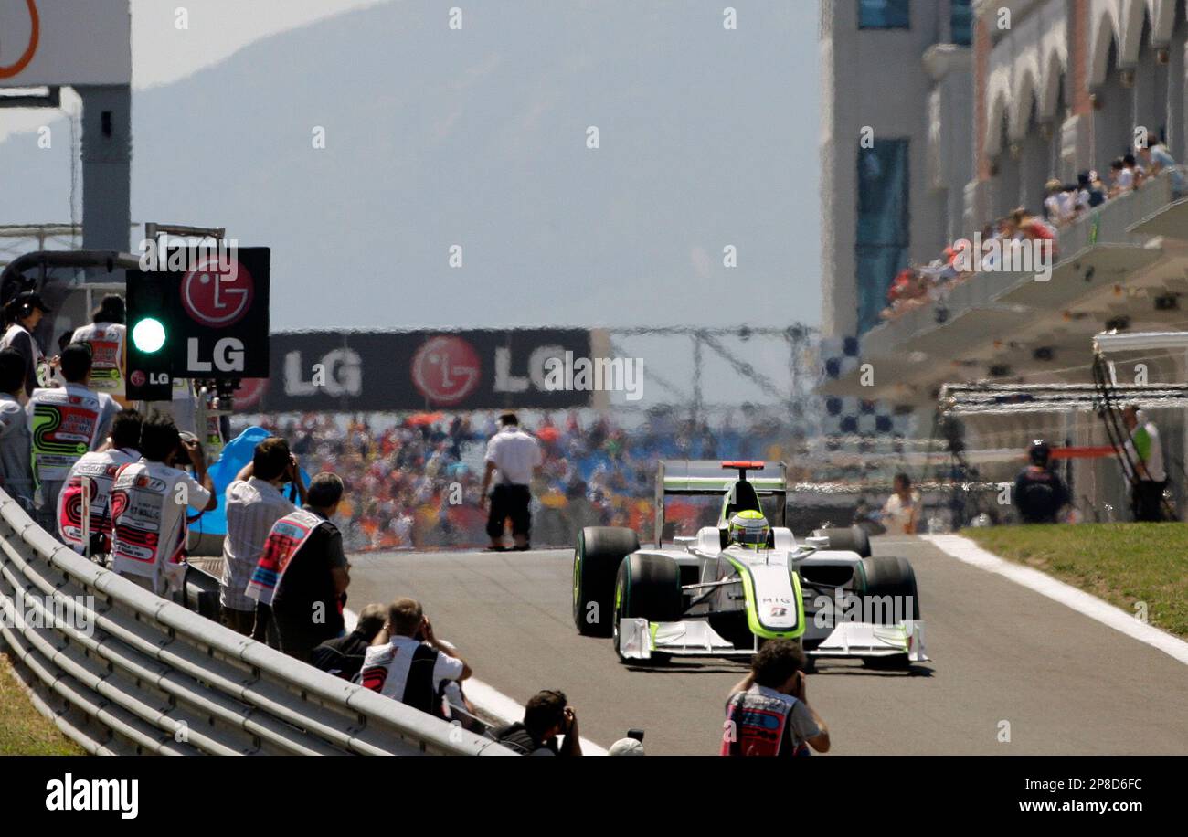 Brawn GP driver Jenson Button of Britain steers his car to set the ...