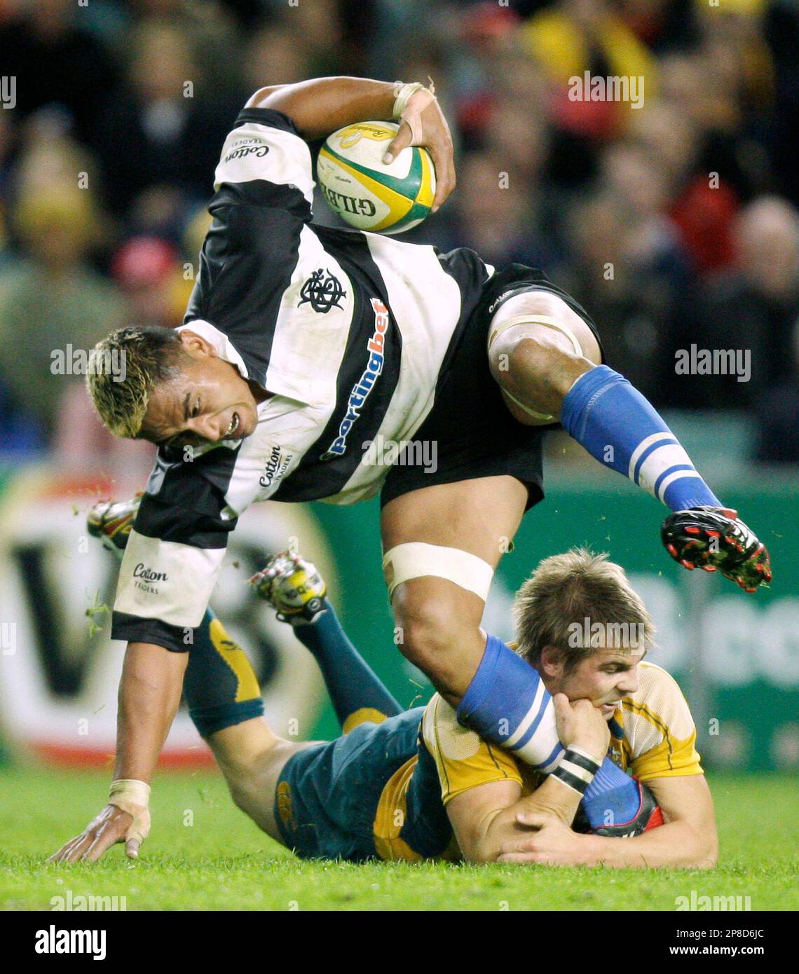 The Barbarians' Jerry Collins of New Zealand, top, has his leg wrapped ...
