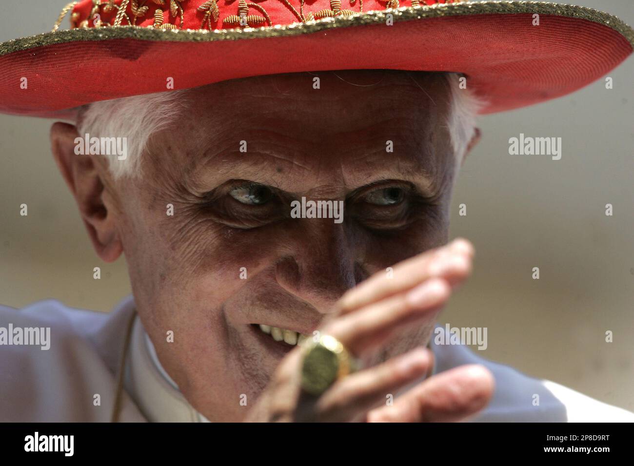 Pope Benedict XVI looks on wearing his red Saturn hat, during the ...