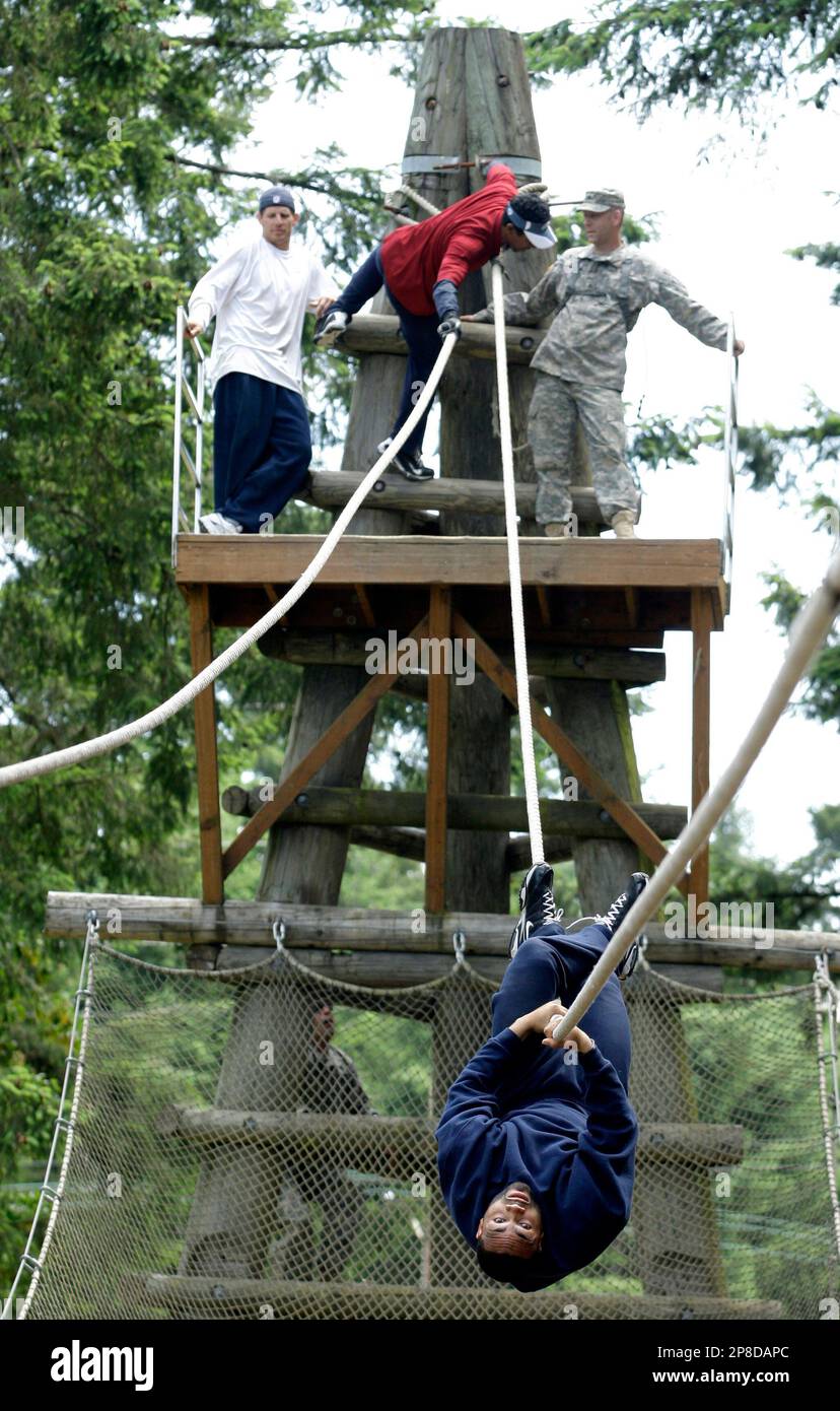 Seattle Seahawks quarterback Seneca Wallace makes his way down a rope ...