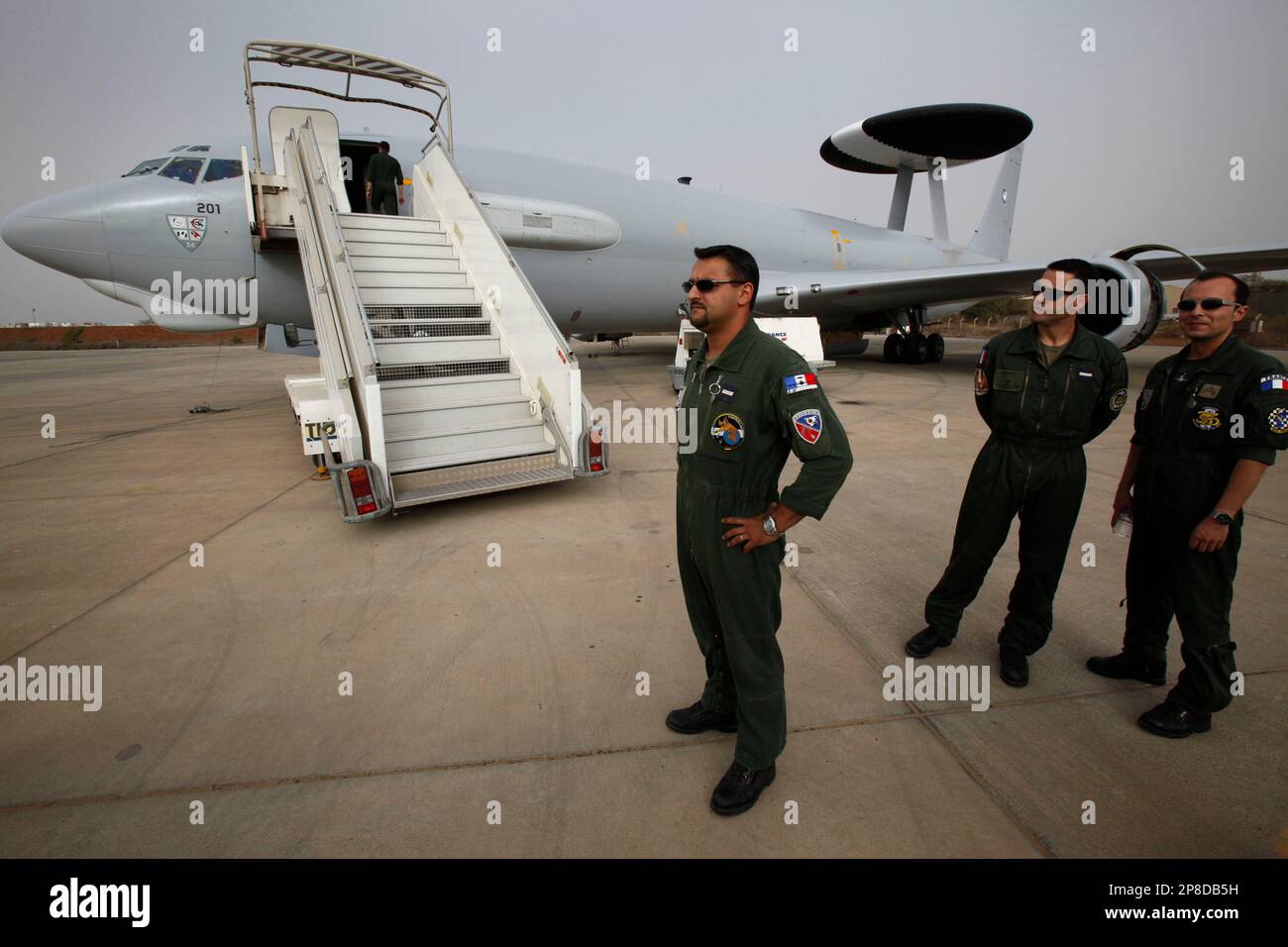 Members of the flight crew of a French AWACS radar plane stand on the ...