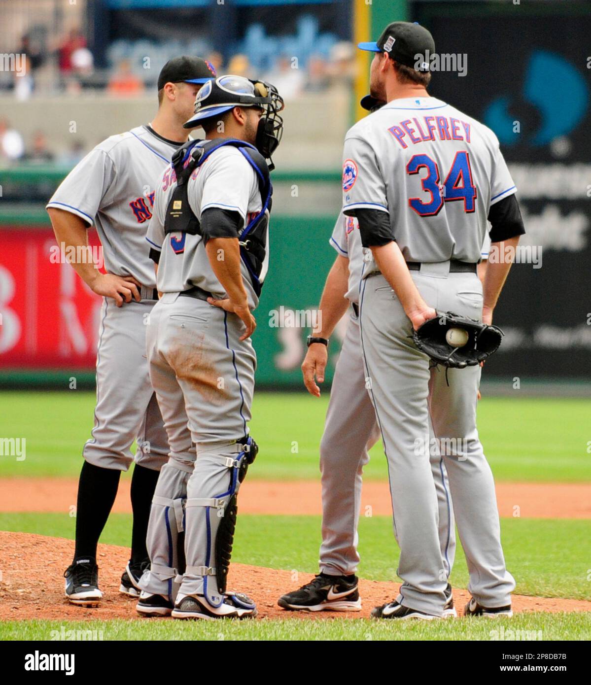 New York Mets, from left, Alex Cora, Omir Santos, and starting pitcher ...