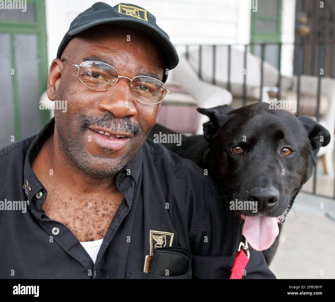 Jessie Pullins and his dog J.J. pose for a photograph on the steps of ...