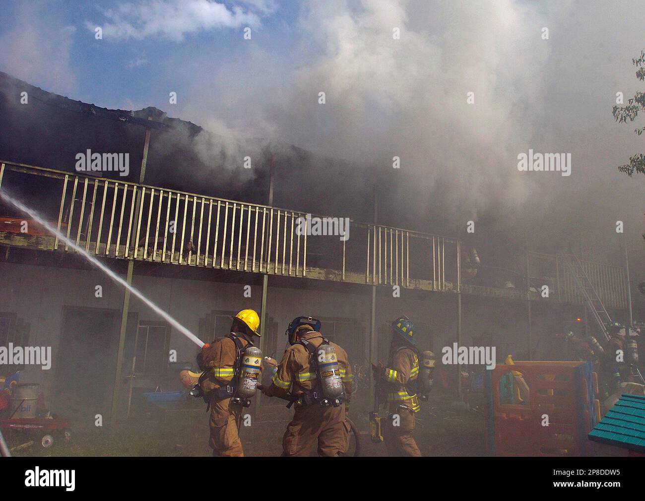 Smoke billows out of a home as Lewiston firefighters work to subdue a ...