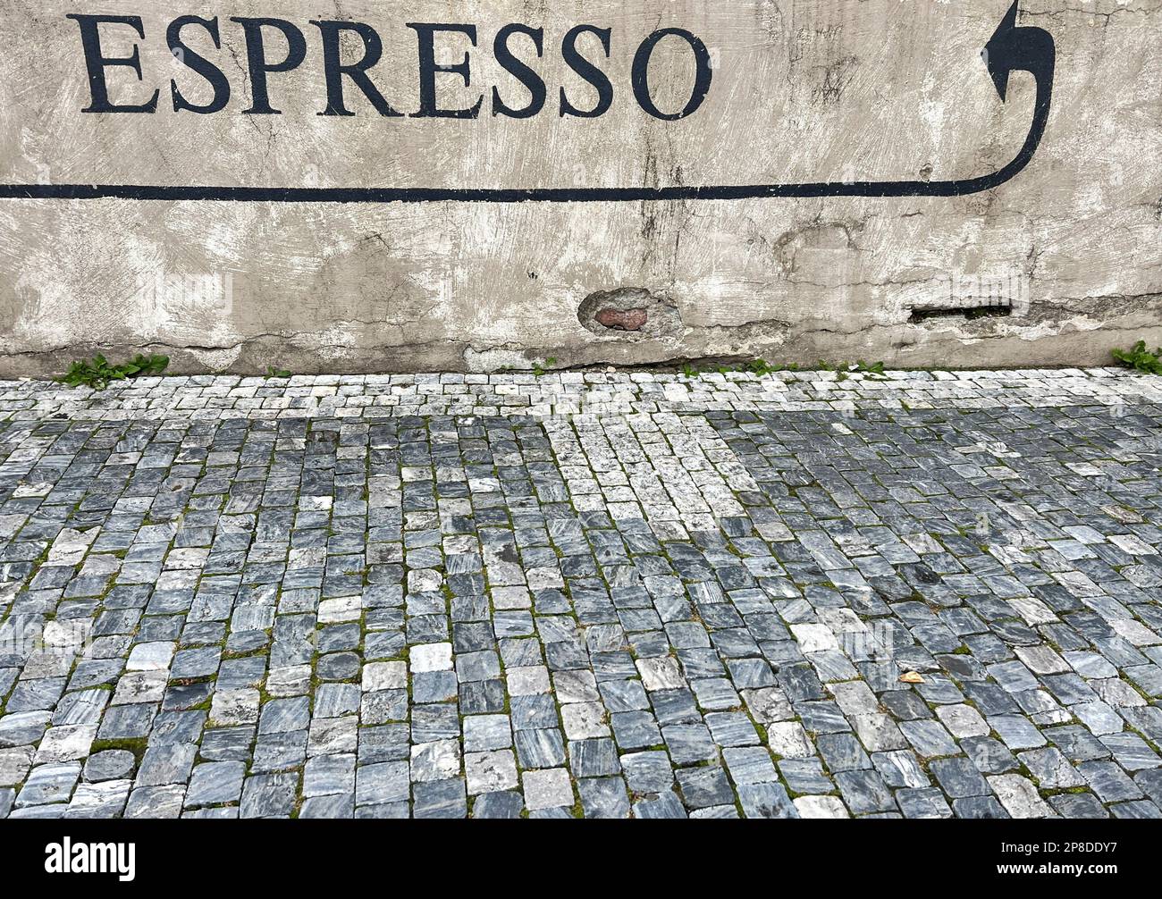espresso, espresso sign with a black arrow on wall at street with ...