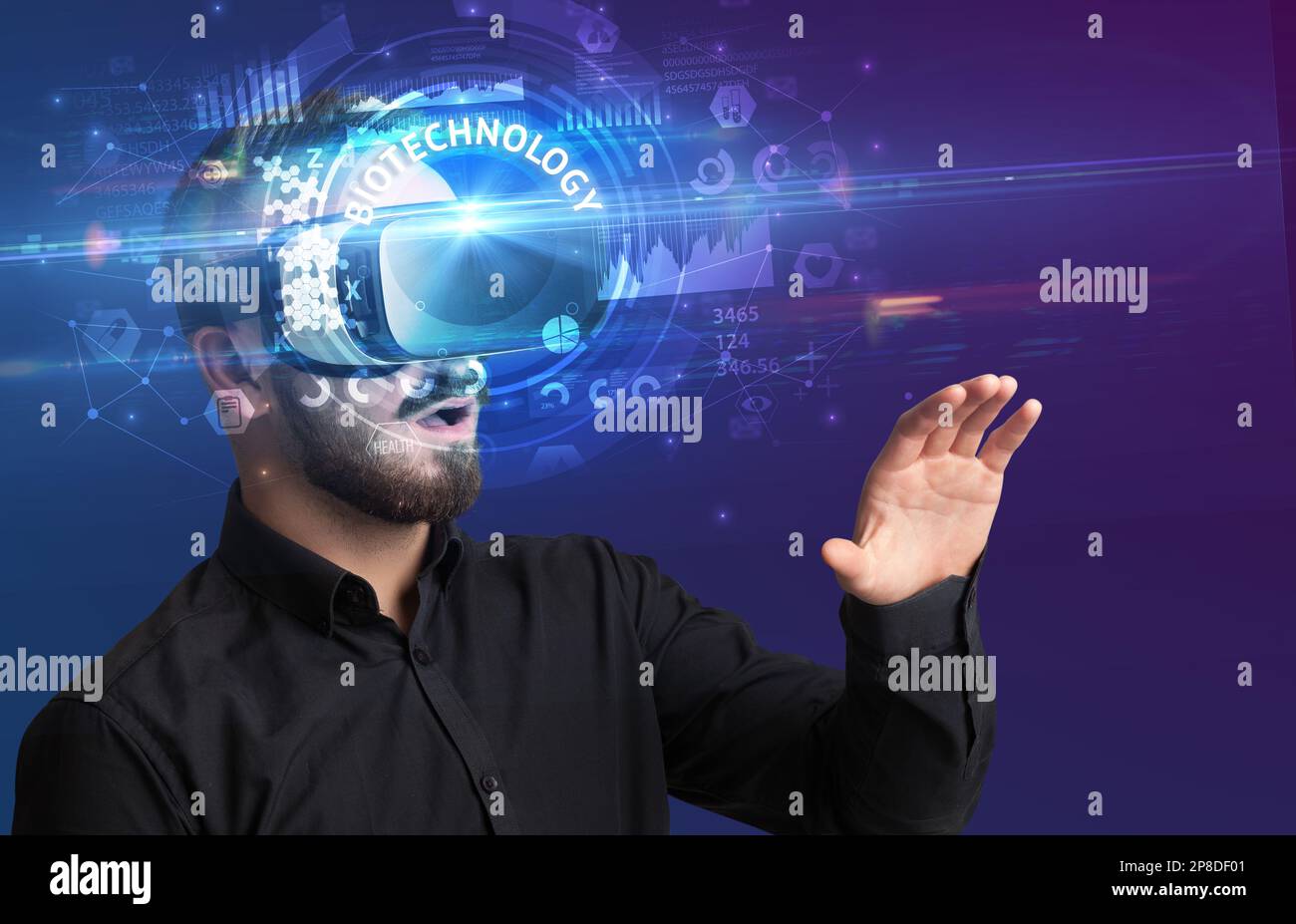 Businessman looking through VR glasses Stock Photo - Alamy