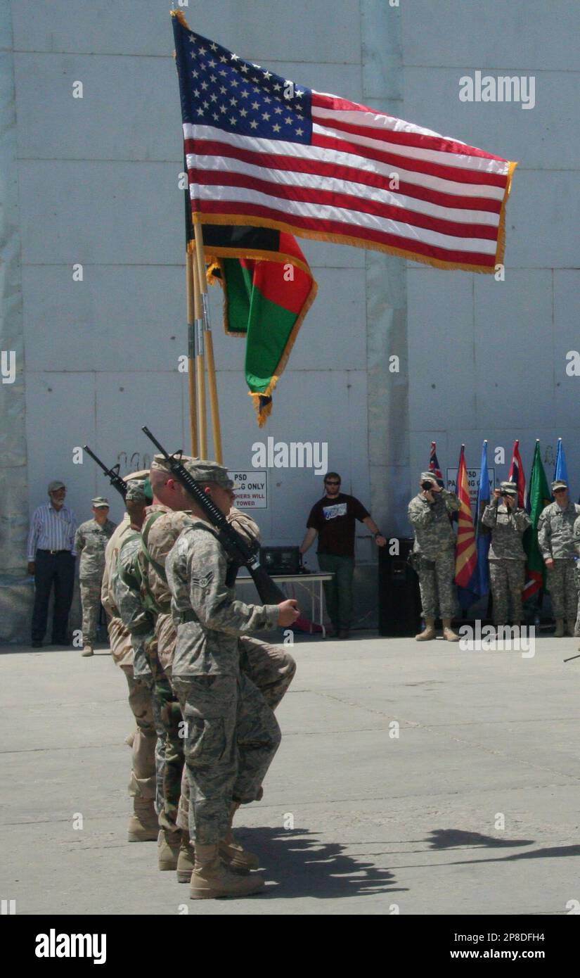 U.S. and Afghan flags are seen held by U.S. soldiers during the change ...
