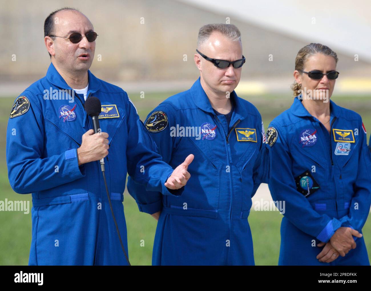 Space shuttle Endeavour commander Mark Polansky, left, aswers a ...