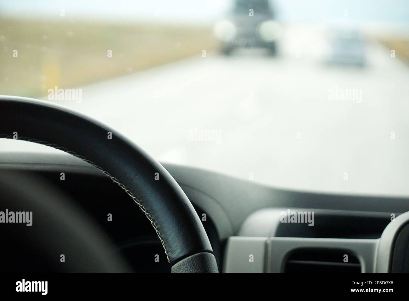 Driving a car - perspective of a driver - bokeh effect Stock Photo - Alamy