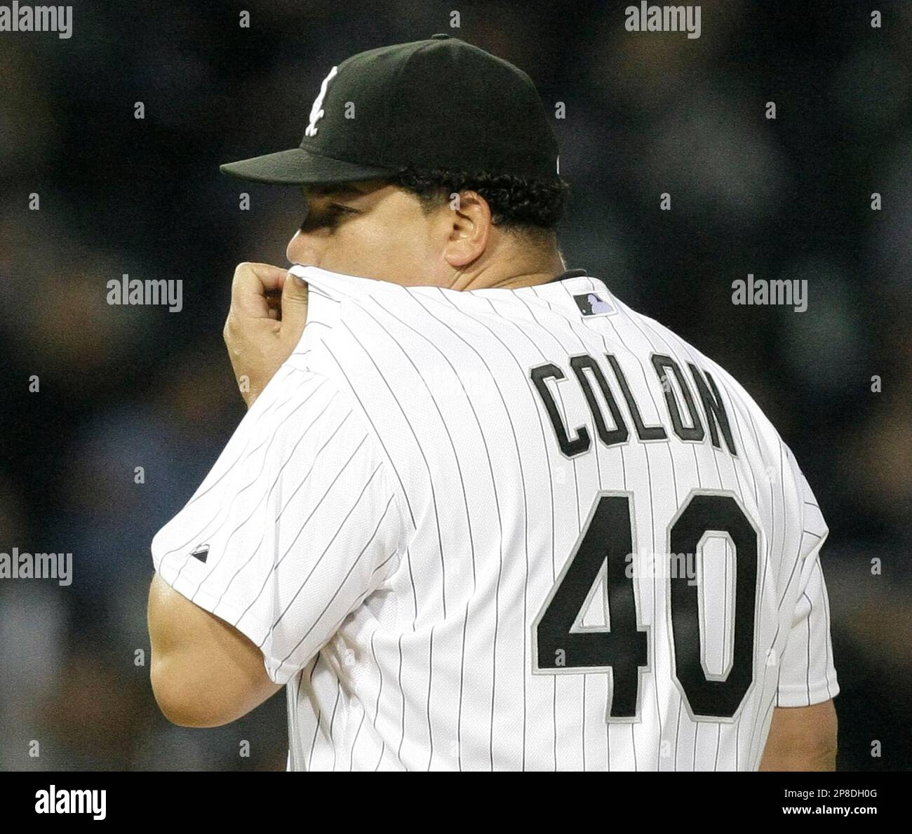 Chicago White Sox starting pitcher Bartolo Colon wipes the sweat from ...