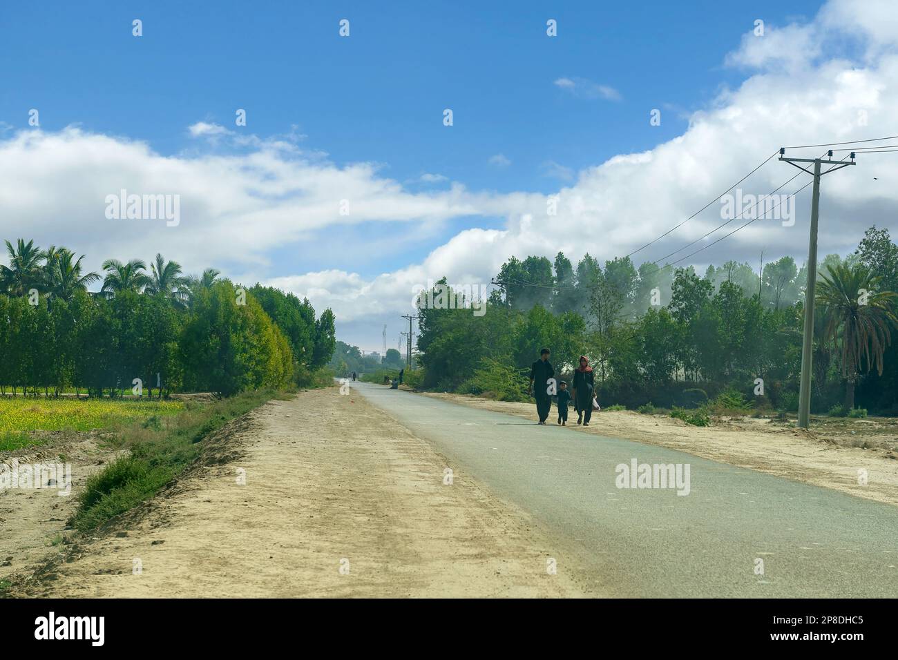 villagers Couple with kids walking on road side. village life Sindh ...