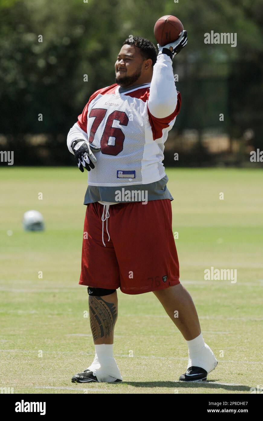 Arizona Cardinals guard Deuce Lutui attempts to throw the ball to a ...