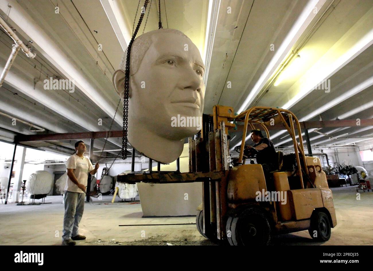 Jesus Flores, left, and Felipe Chuy, right, move sculptor David Adickes ...