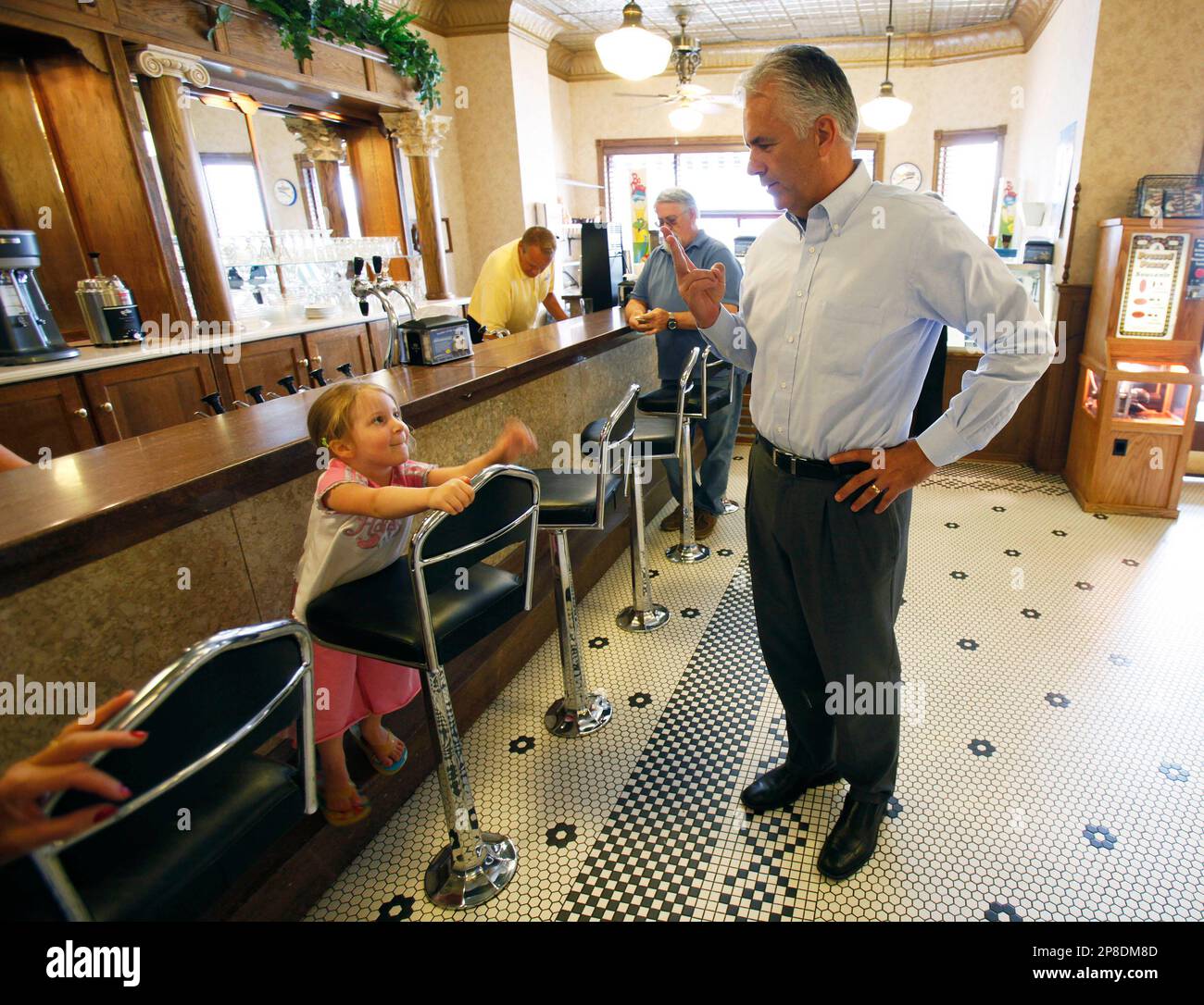 U.S. Sen. John Ensign, R-Nev., talks with four-year old Hailey Netley ...